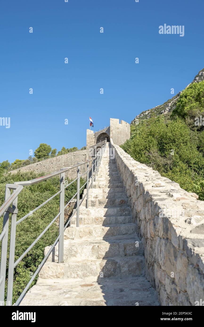 Narrow stone passage stairs on Wall of Ston aong hills in Croatia ...