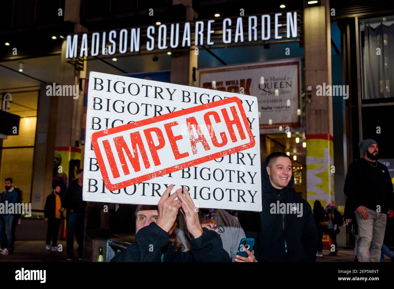 Hundreds of New Yorkers took to the streets holding a loud booing ...