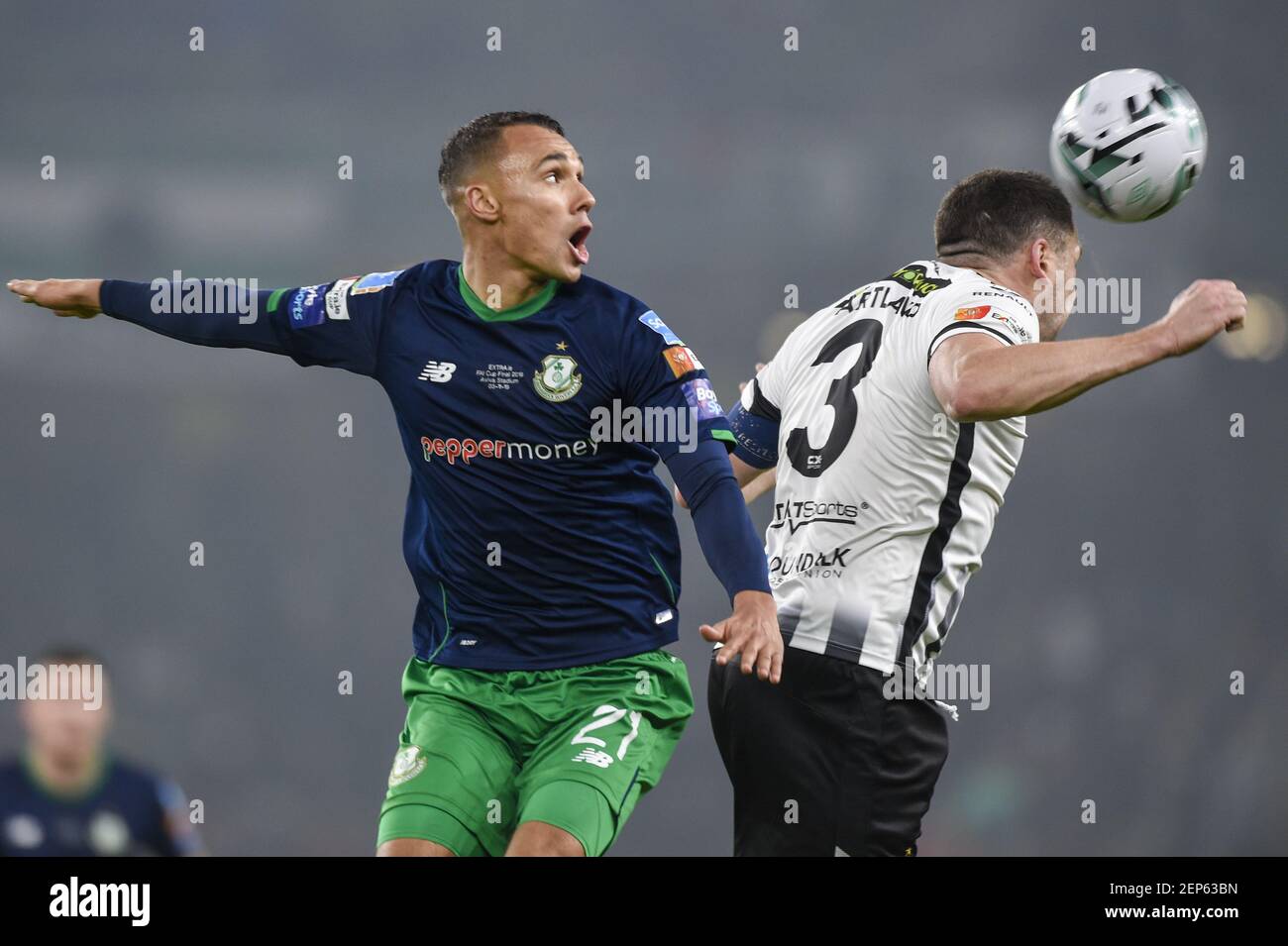 Graham Burke of Shamrock and Brian Gartland of Dundalk jump to the ball ...