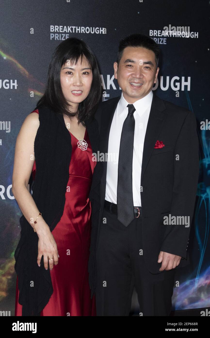 A guest (L) and Eric Yuan, CEO of Zoom attend the eighth annual ...