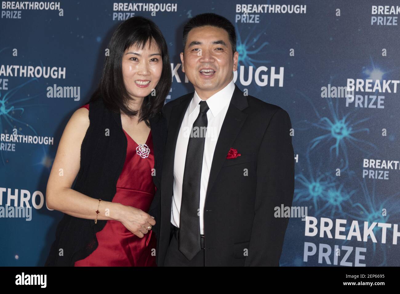 A guest (L) and Eric Yuan, CEO of Zoom attend the eighth annual ...