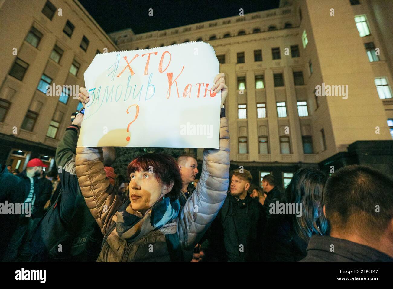 A woman holds a placard which asks "Who kill Gandziuk?" at a rally to ...
