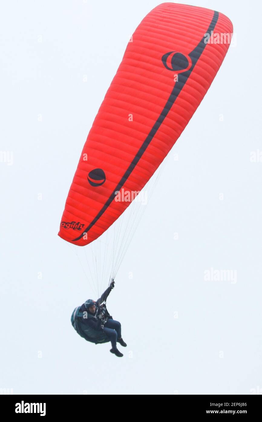 A paraglider pilot performs stunt flying in Zigui county, Yichang city ...