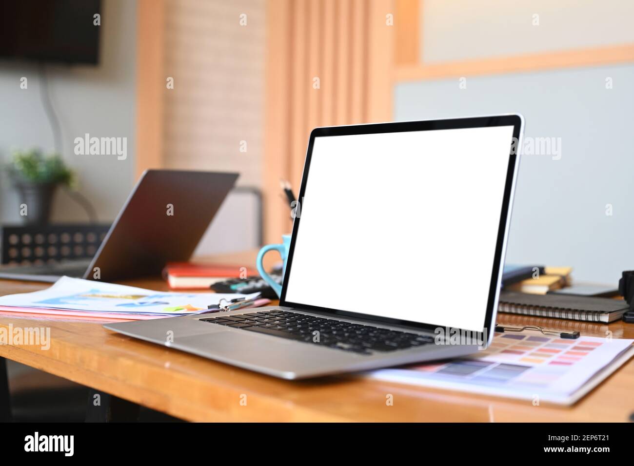 An open laptop computer with blank screen on wooden office desk Stock ...