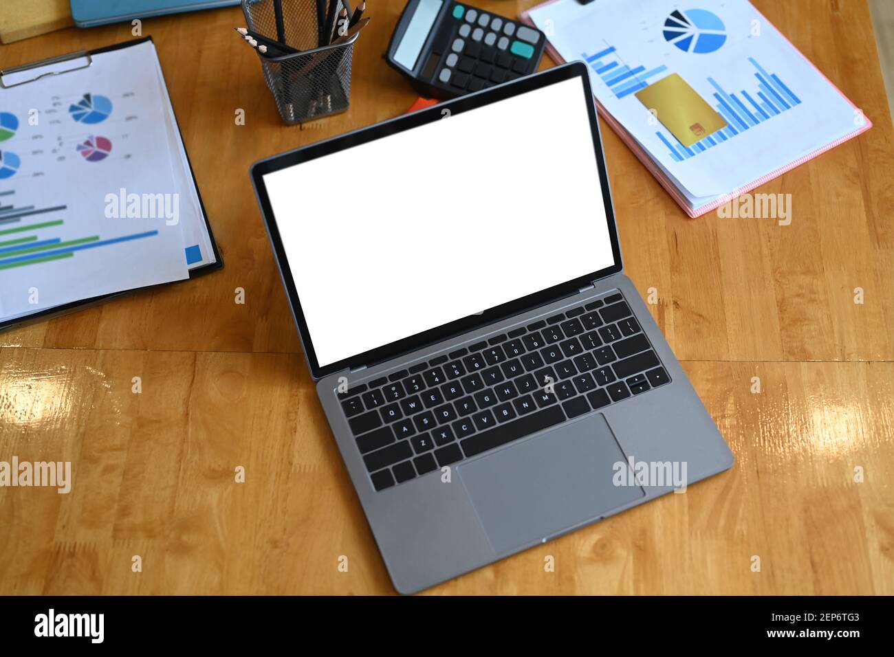 Overhead shot of laptop computer with white screen on wooden office ...