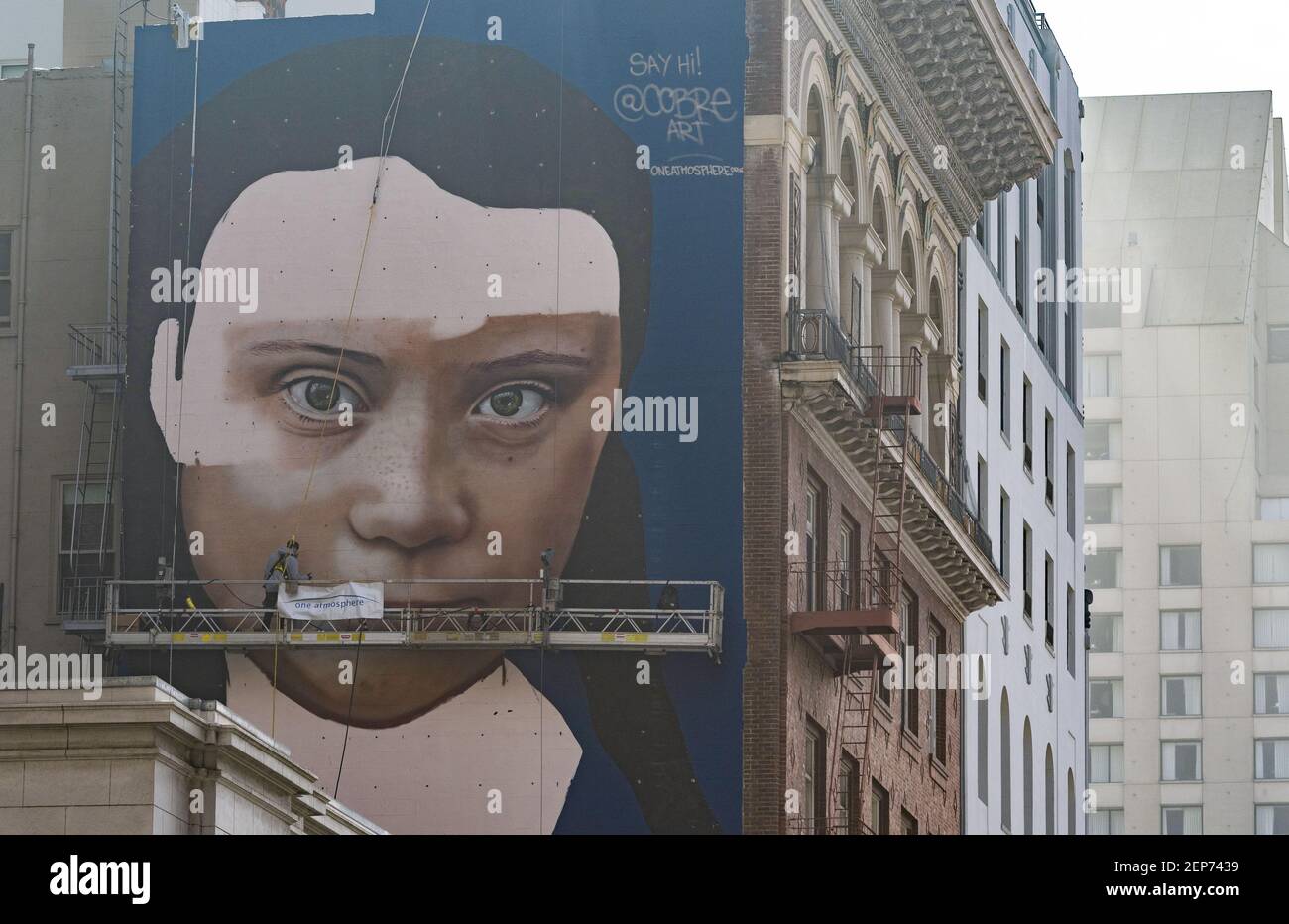 A mural of Swedish climate activist Greta Thunberg is being painted by ...