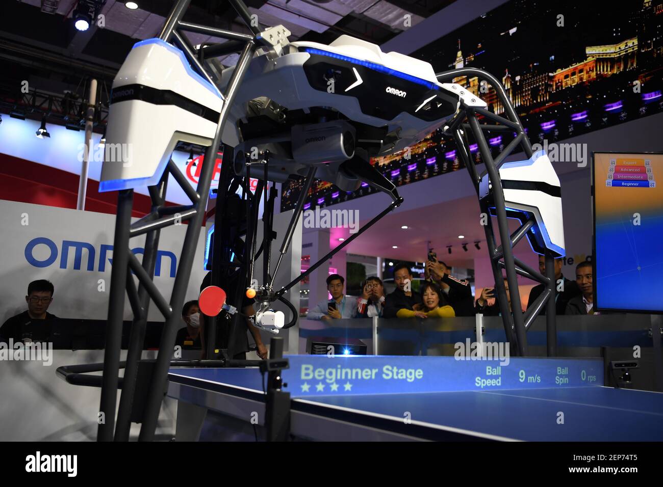 People watch Forpheus, the ping-pong robot designed by Omron playing ...