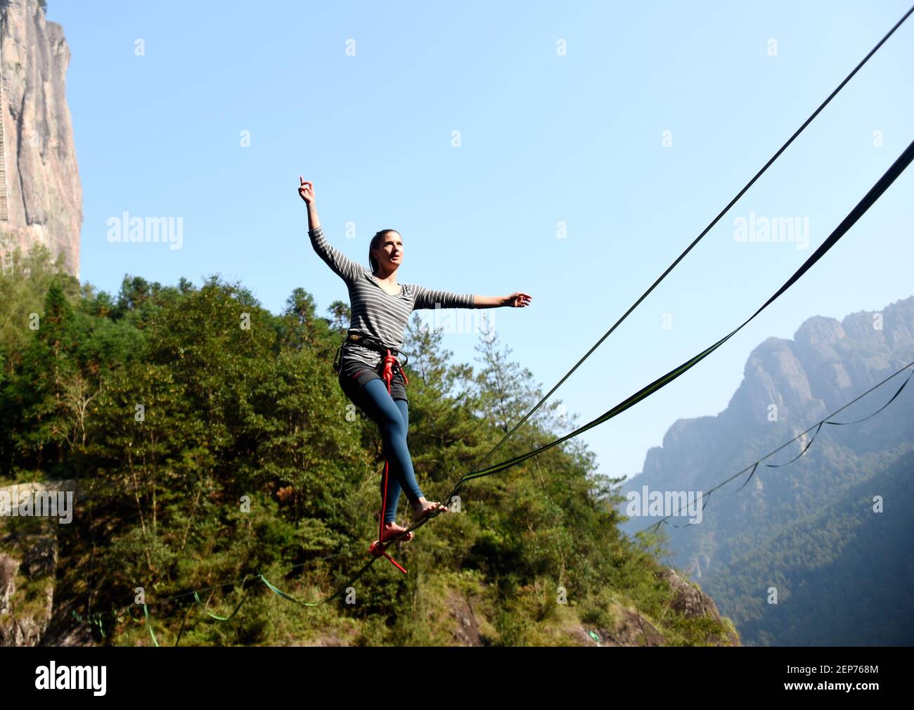 A participant walks on the slackline in the air in Shenxianju National ...