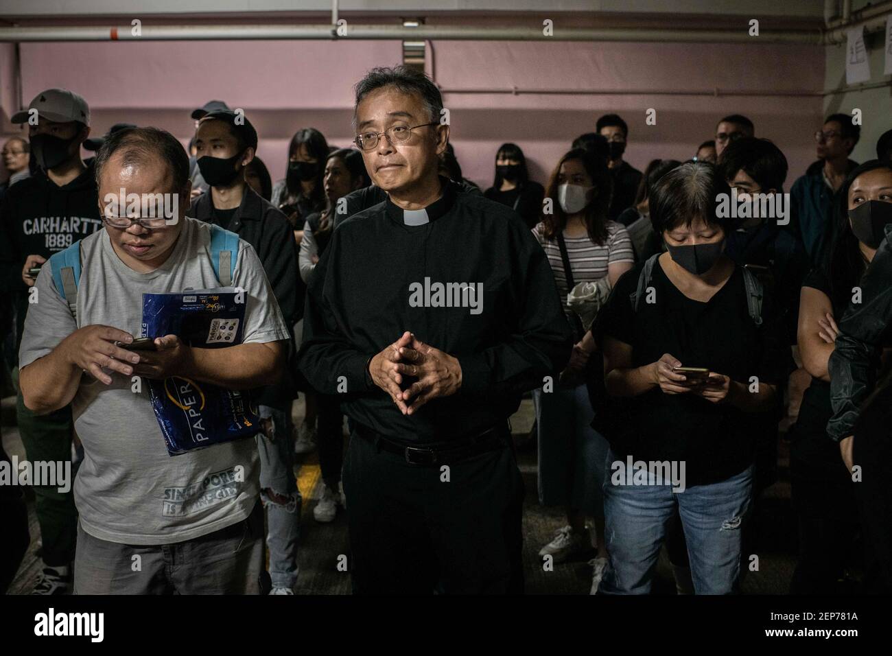 A catholic priest at a religious ceremony in the memory of Alex Chow ...