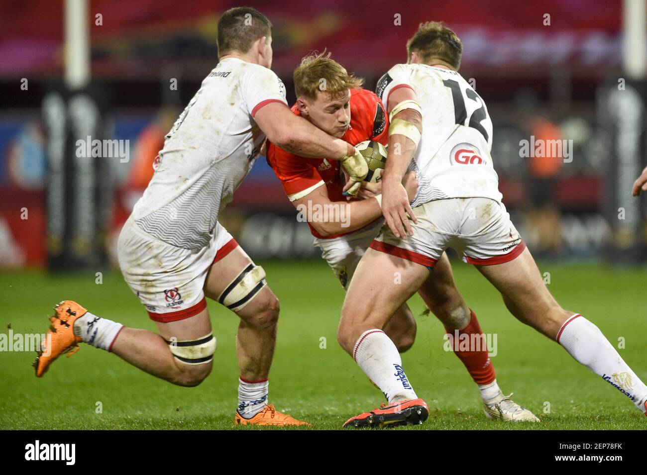 Mike Haley of Munster tackled by Nick Timoney of Ulster and Stuart ...