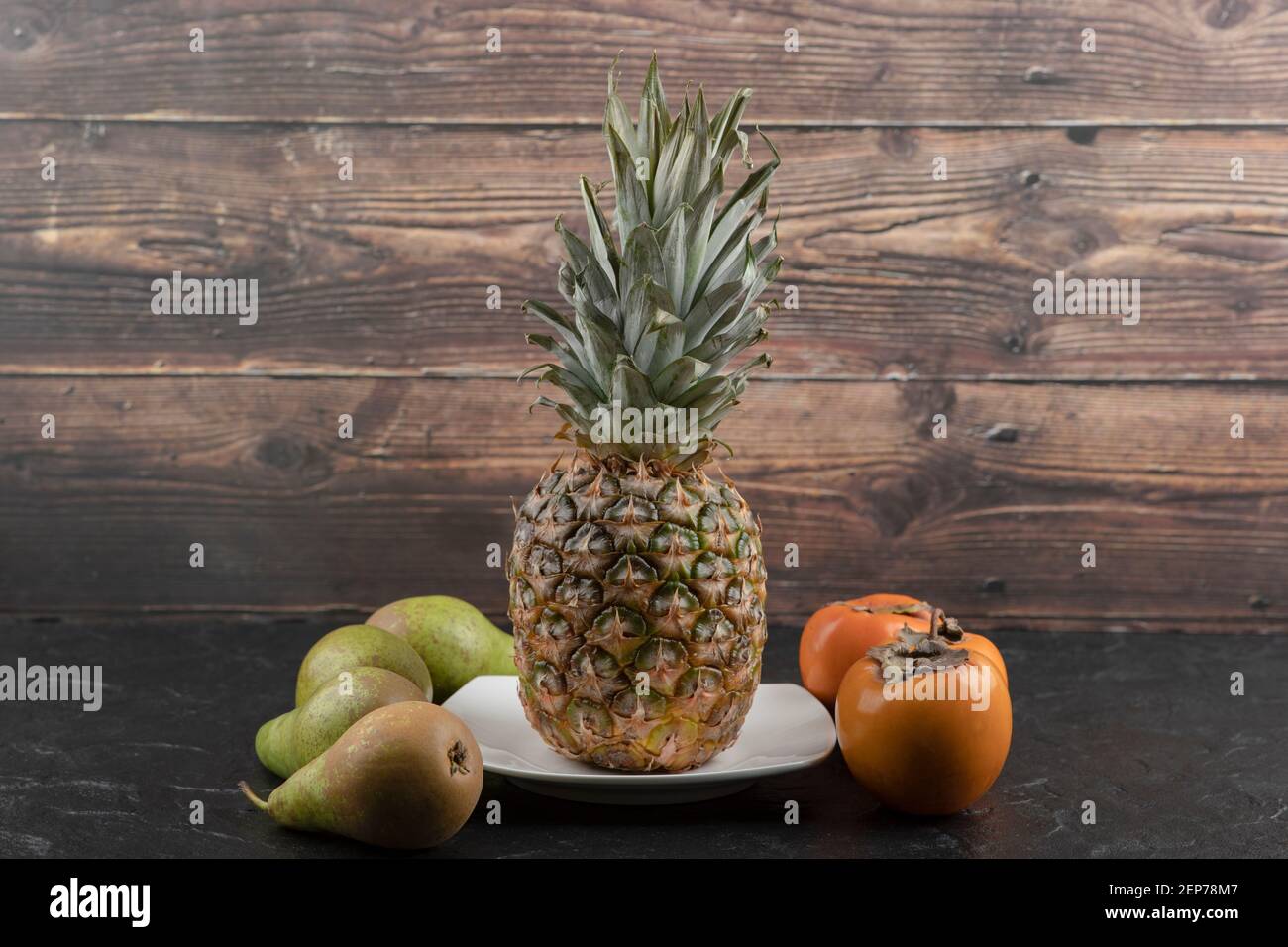 Delicious fresh fruits and empty plate on black surface Stock Photo - Alamy