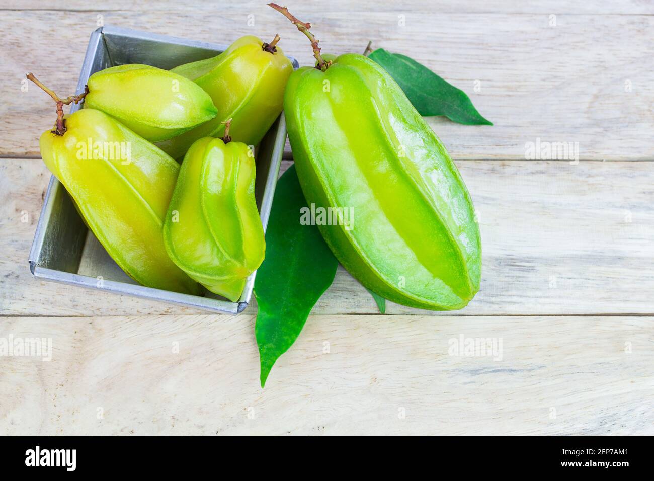 Close up star fruit carambola or star apple ( starfruit ) on wood table ...