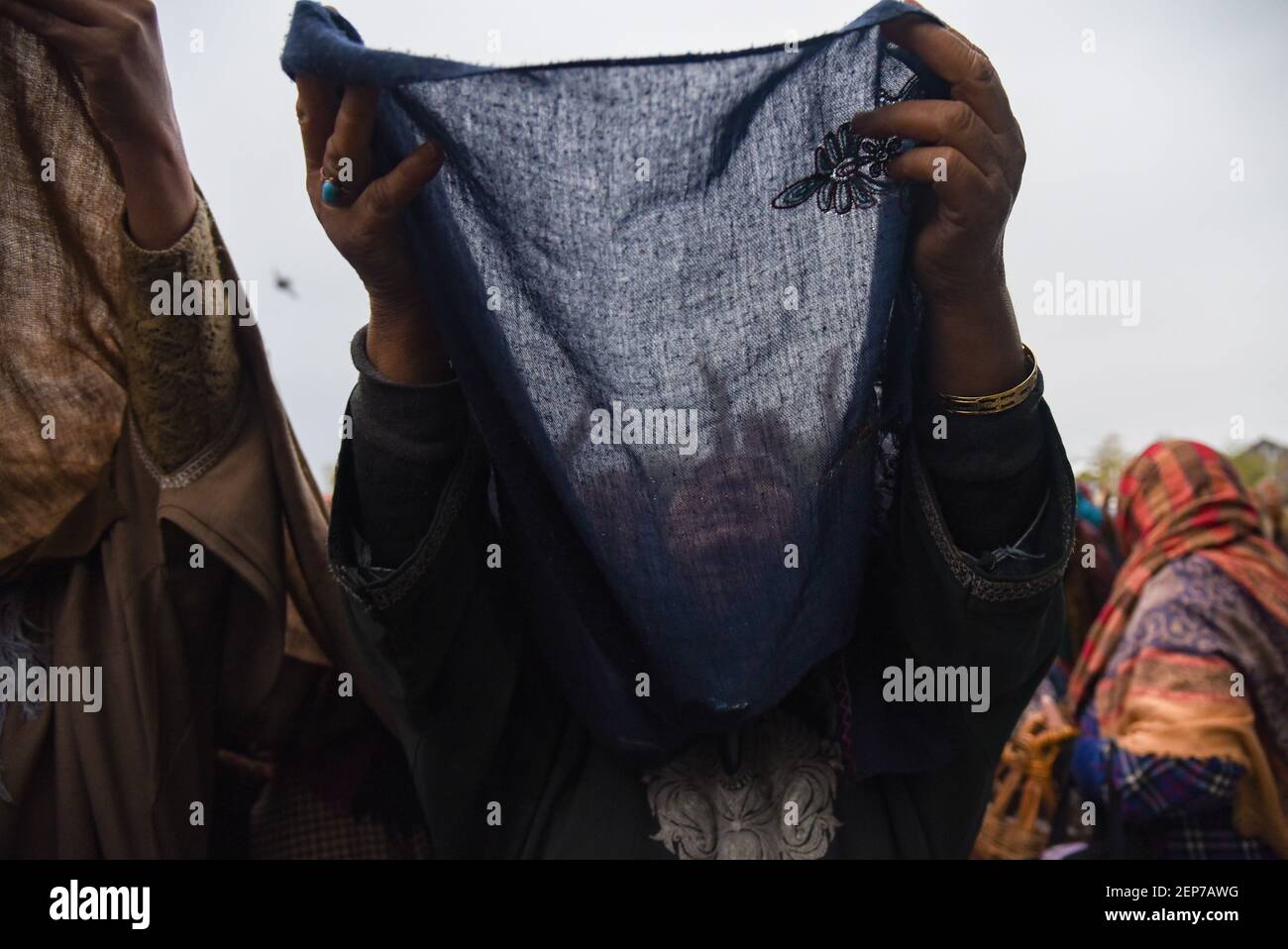 A Kashmiri woman devotee raises her hands while beseeching for ...