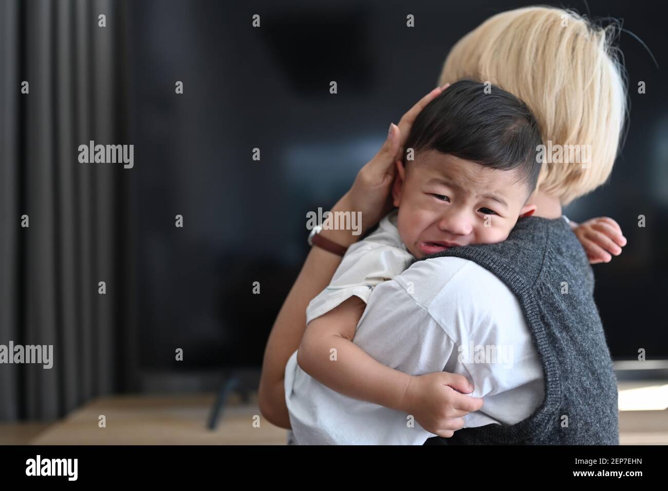 Woman with crying baby photo hi-res stock photography and images - Alamy