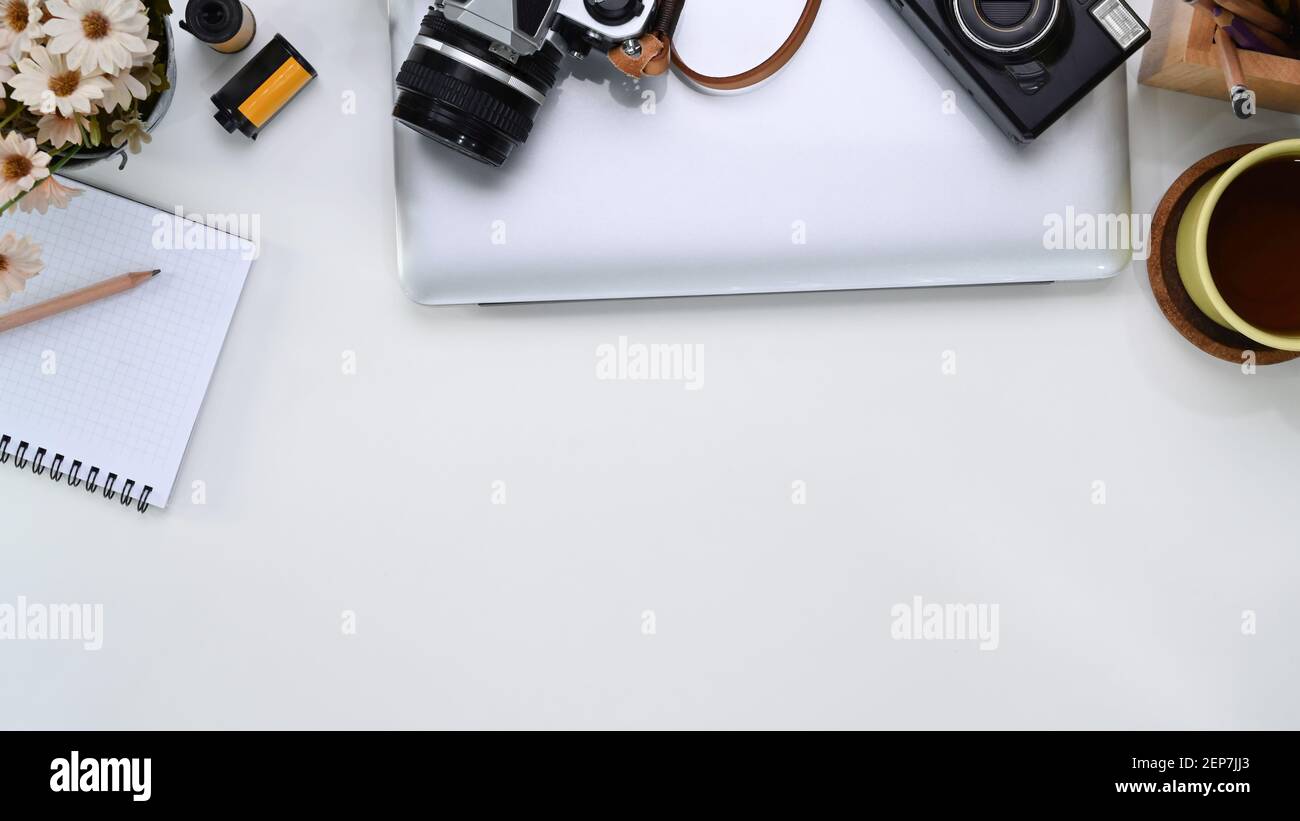 Above view of photographer workplace with laptop, notebook, camera ...