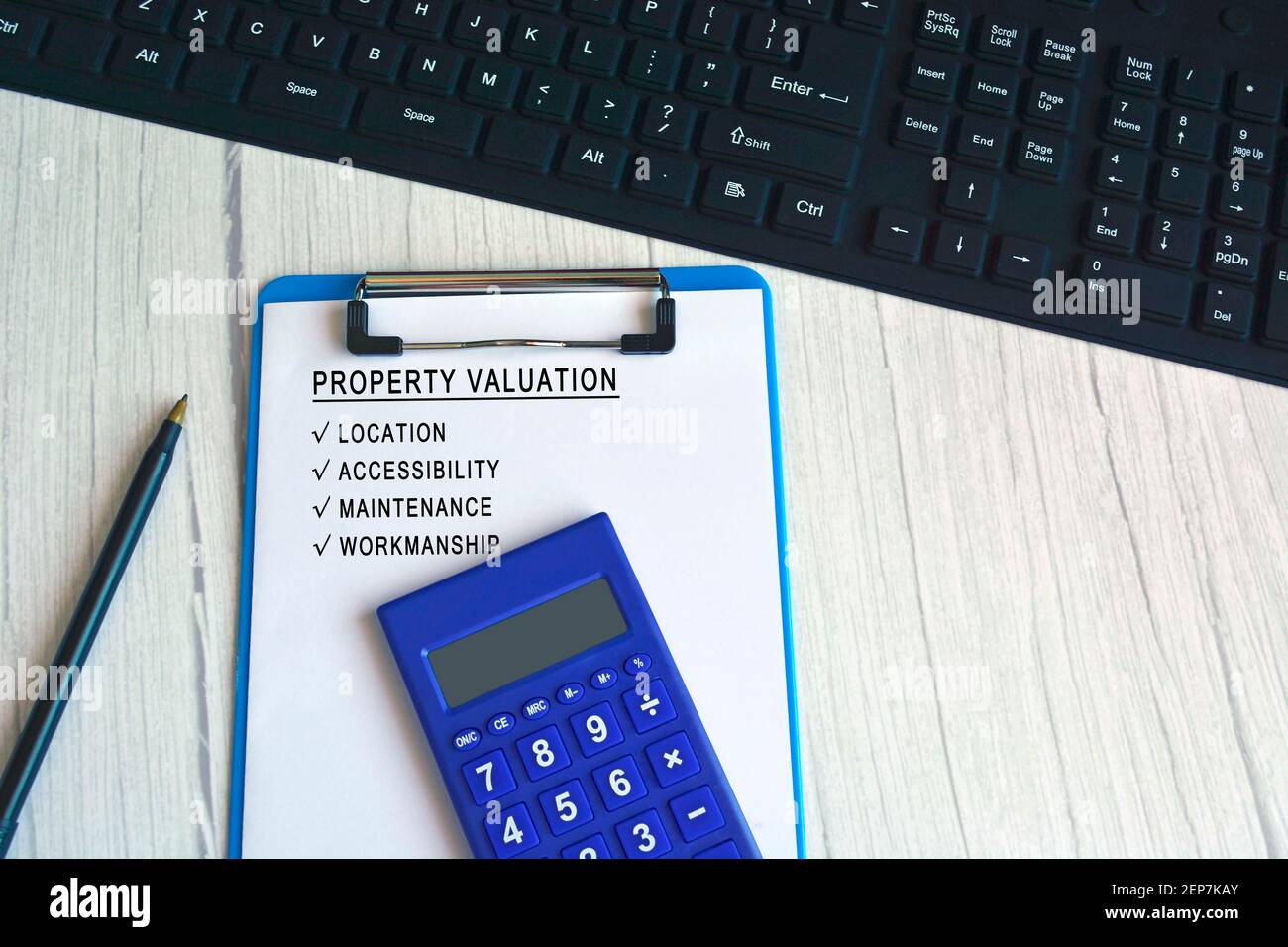 Property valuation checklist text on blue clip board with calculator ...