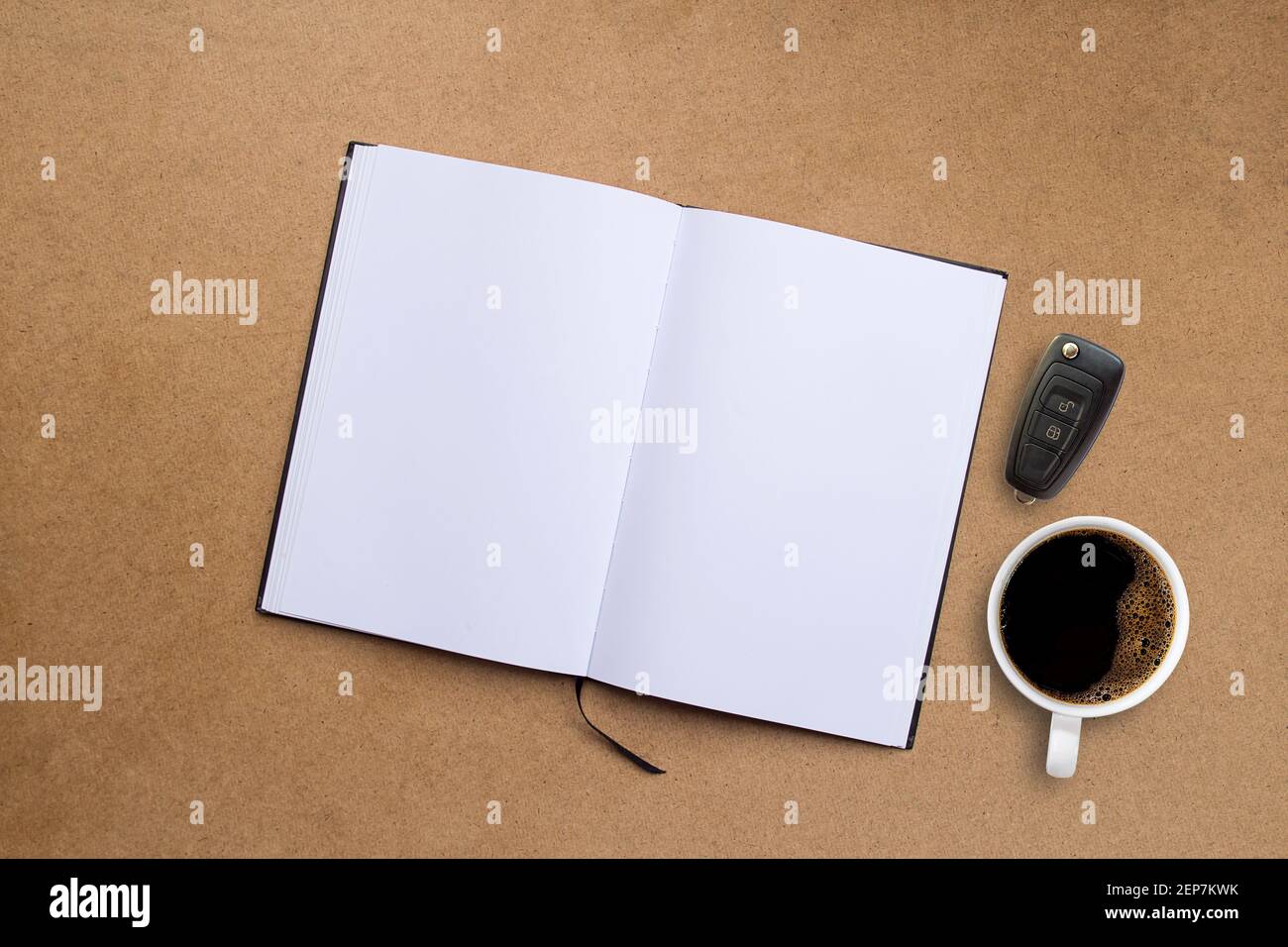 Blank notepad or notebook and coffee cup on brown wood table background ...