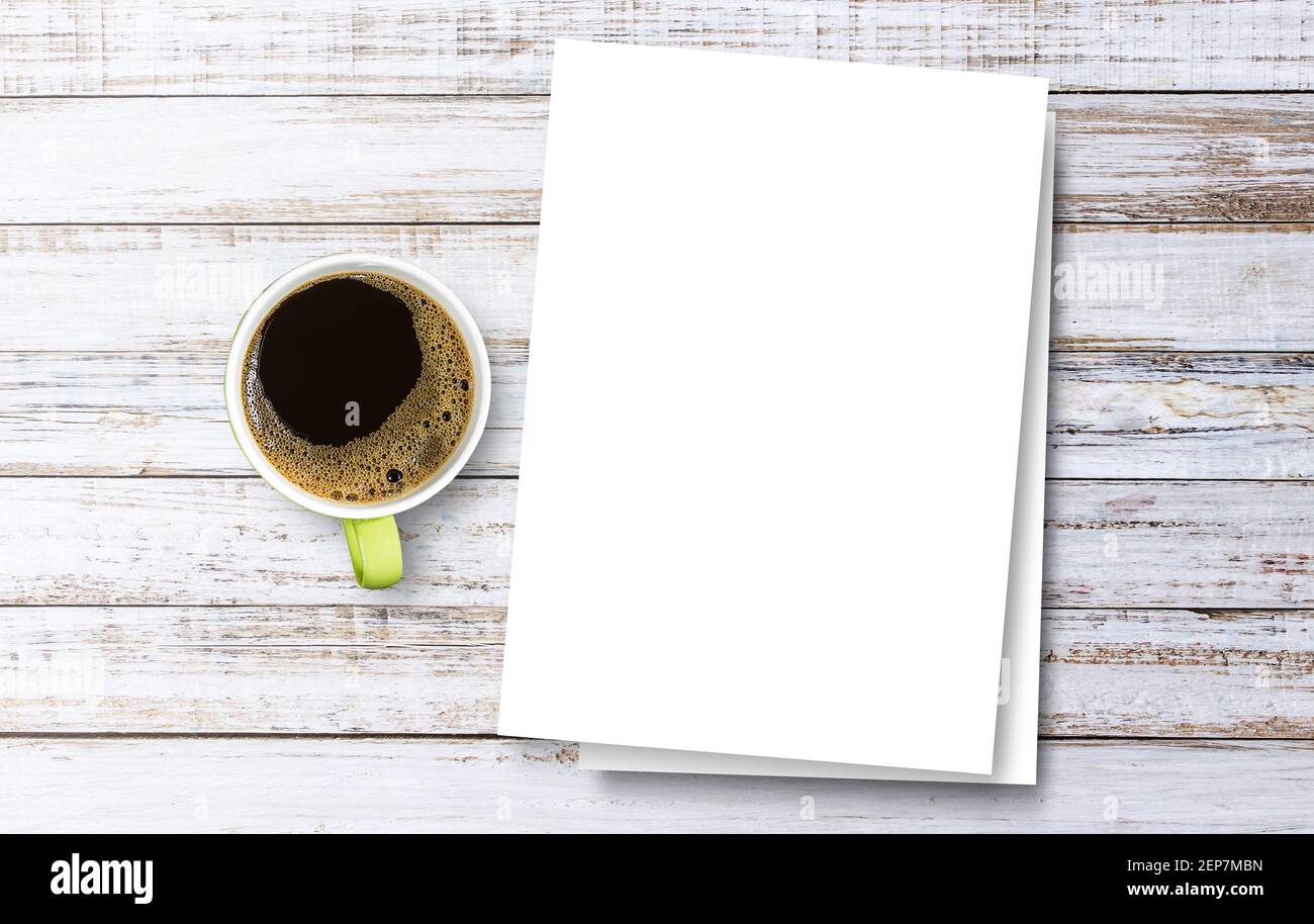 Studio shot. White paper and cup of coffee on wood table background ...