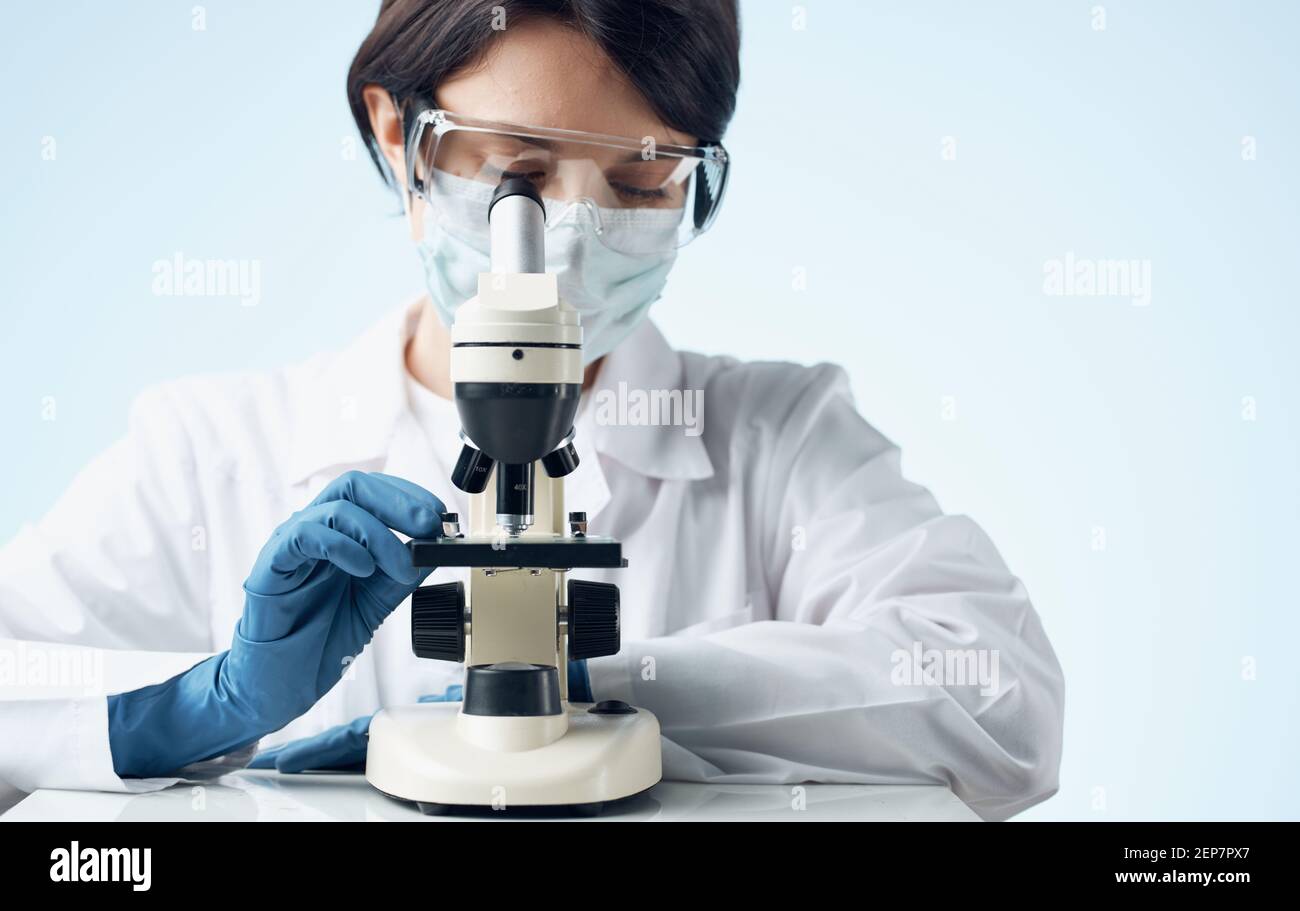 woman looking at microscope laboratory research microorganisms bacteria ...
