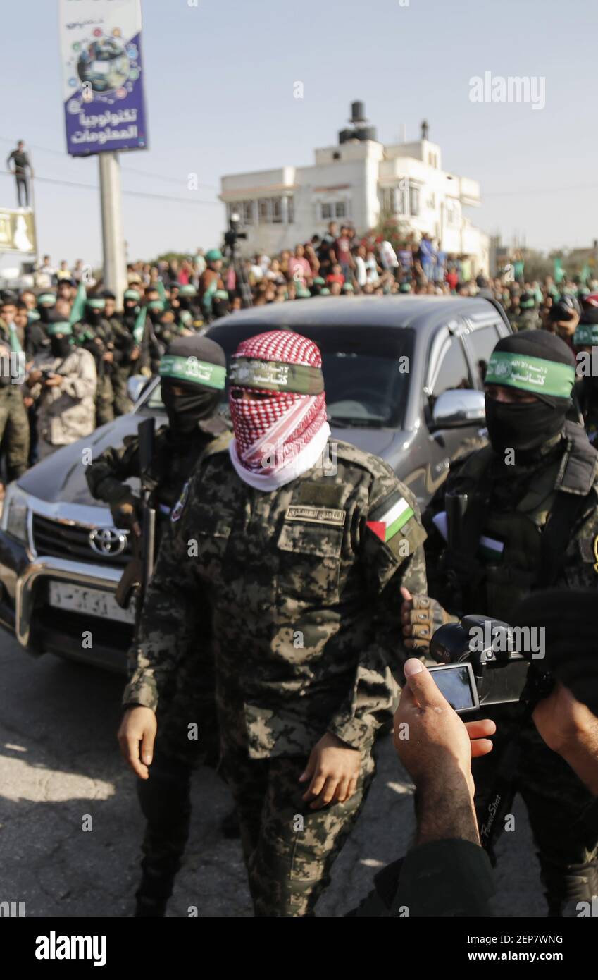 Abu Ubaida, the spokesman of the Izz el-Deen al-Qassam Brigades, walks ...