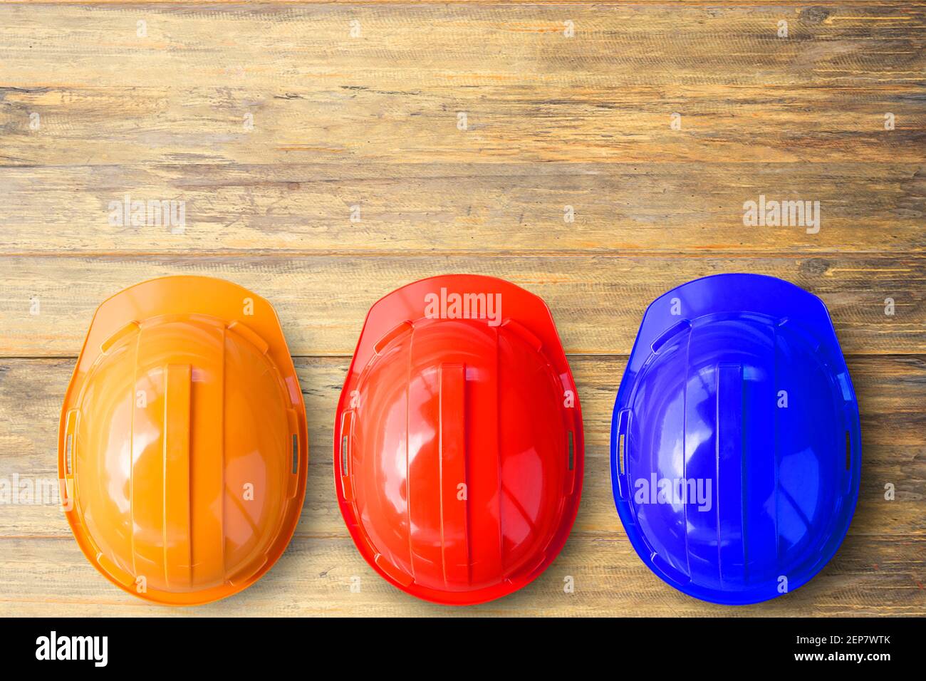 Group of safety engineer helmets on wood background. Industrial safety ...