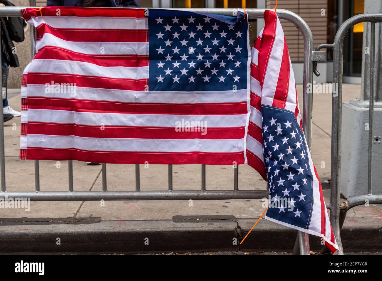 Two American Flags are attached to a barricade at the 100th Veterans ...