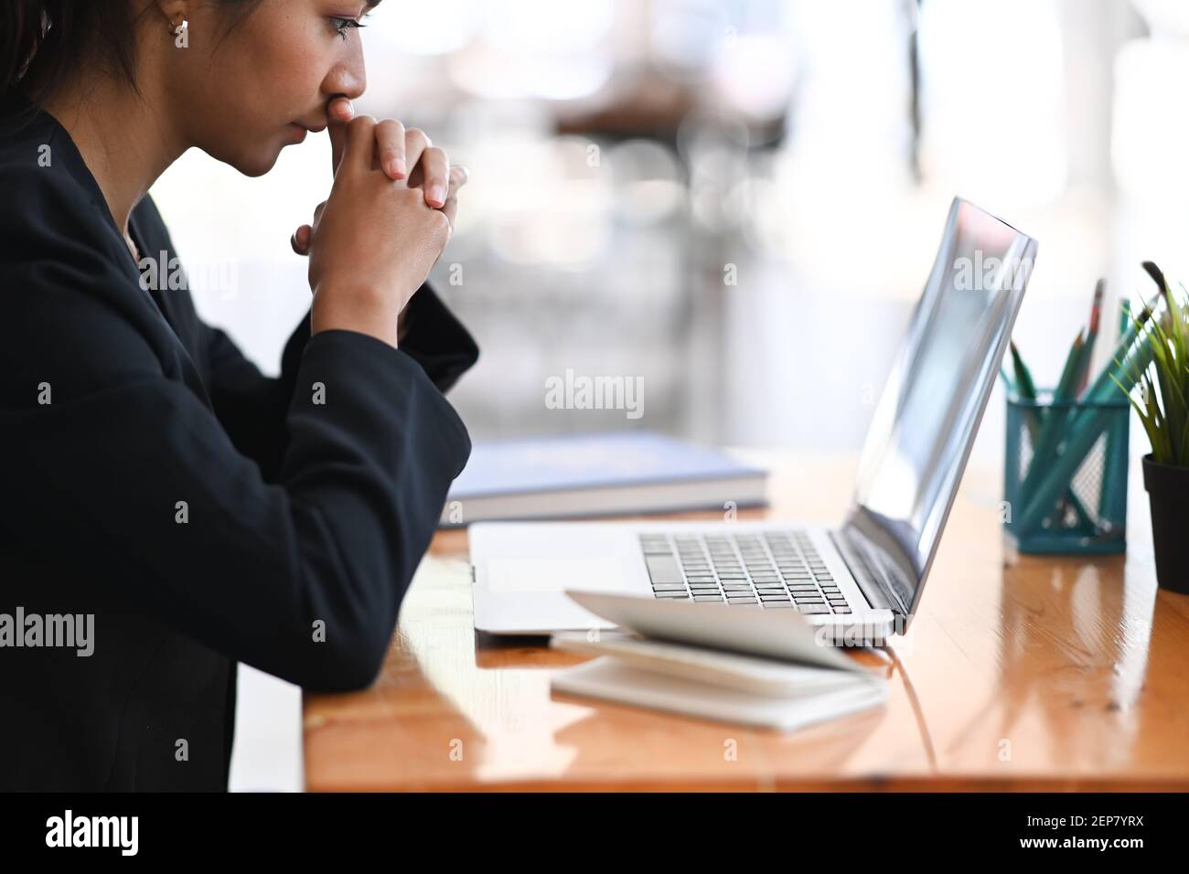 Side view of serious businesswoman concentrate working laptop in office ...