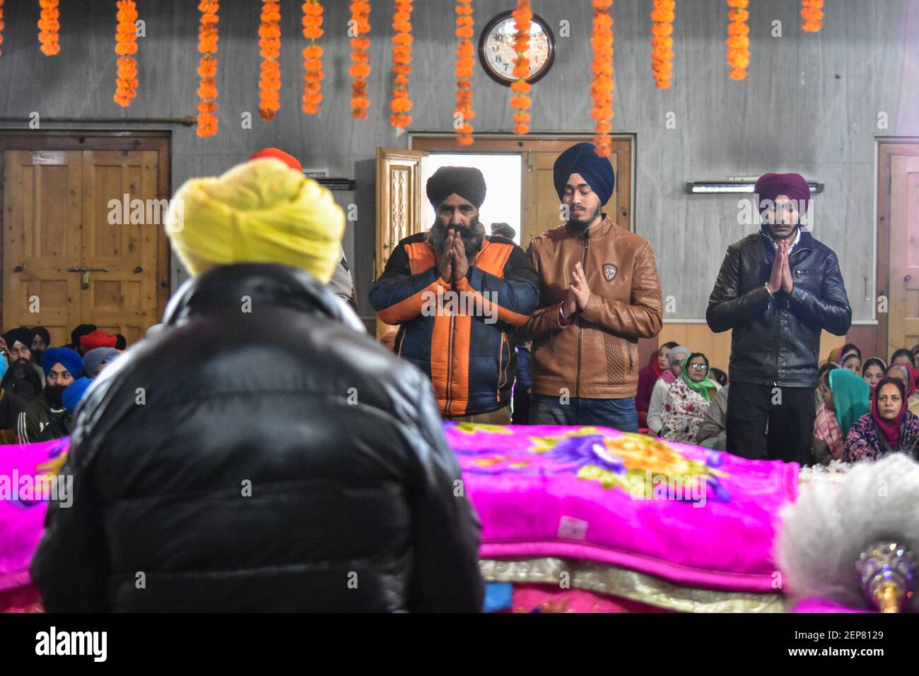 Sikh devotees pray inside a Gurdwara or a Sikh temple during the ...