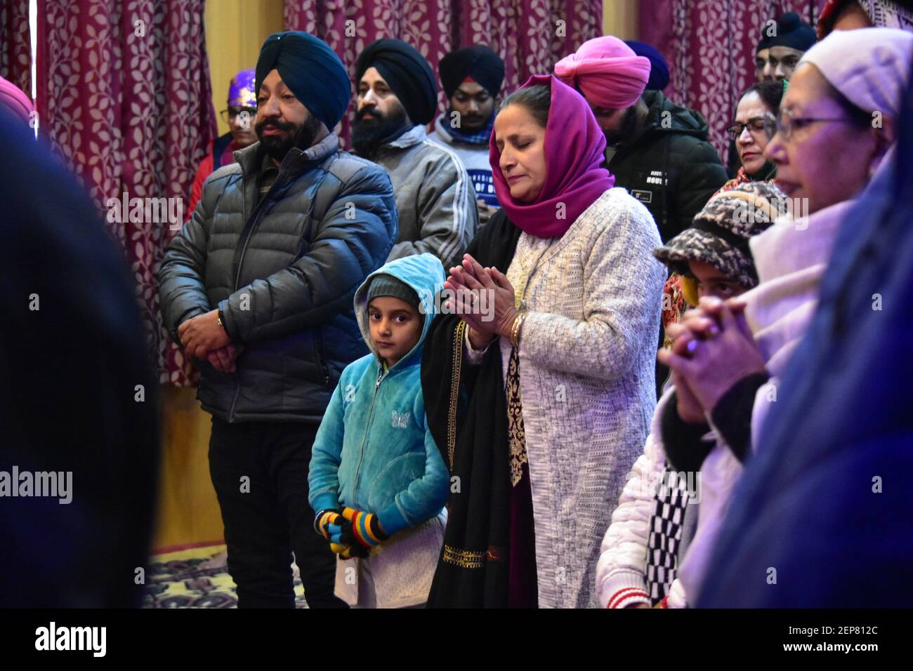 Sikh devotees pray inside a Gurdwara or a Sikh temple during the ...