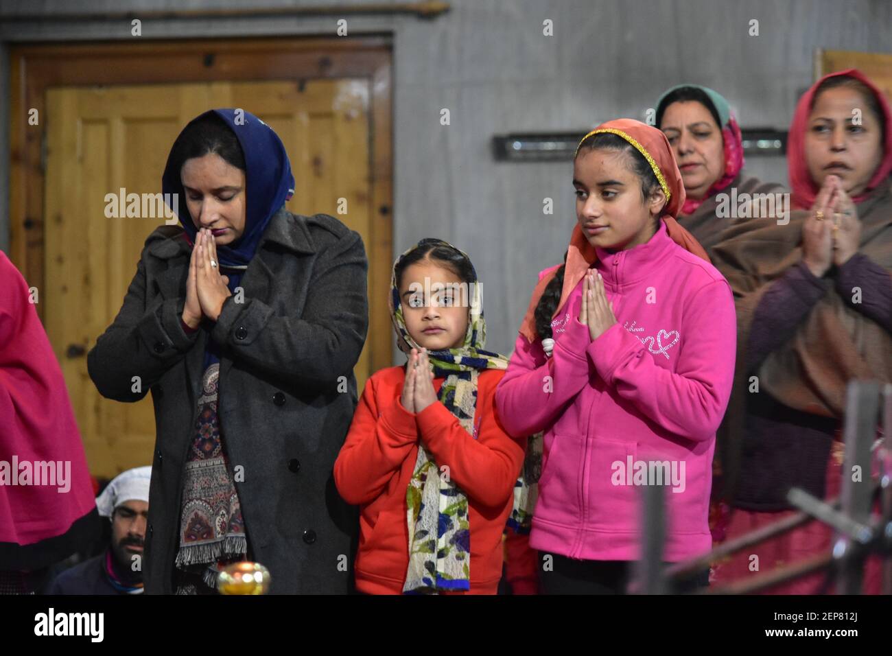 Sikh devotees pray inside a Gurdwara or a Sikh temple during the ...