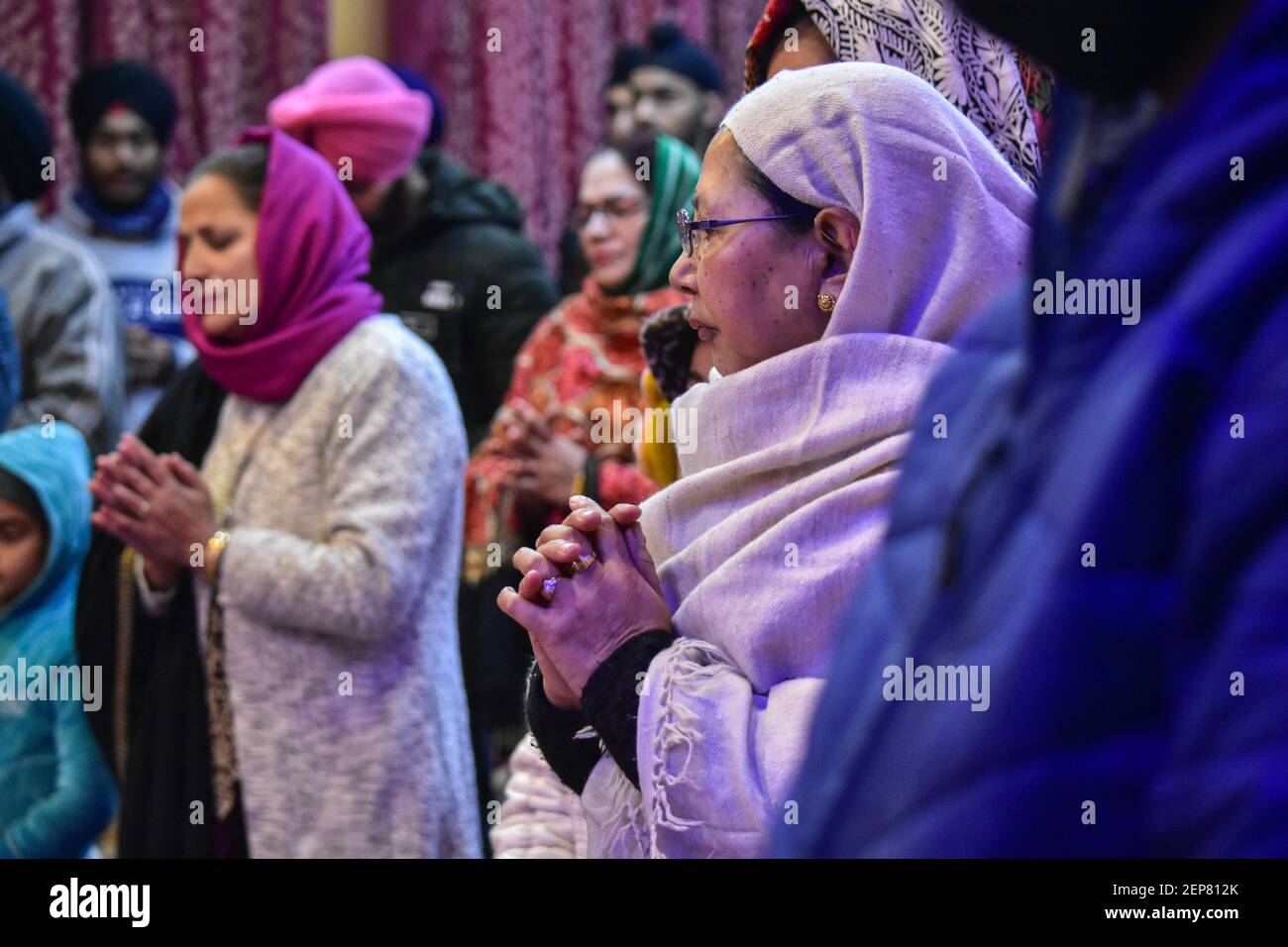 Sikh devotees pray inside a Gurdwara or a Sikh temple during the ...
