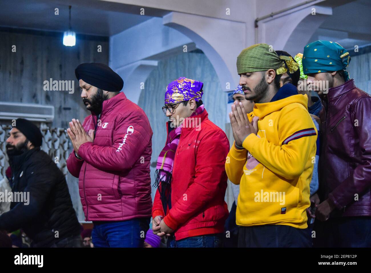 Sikh devotees pray inside a Gurdwara or a Sikh temple during the ...