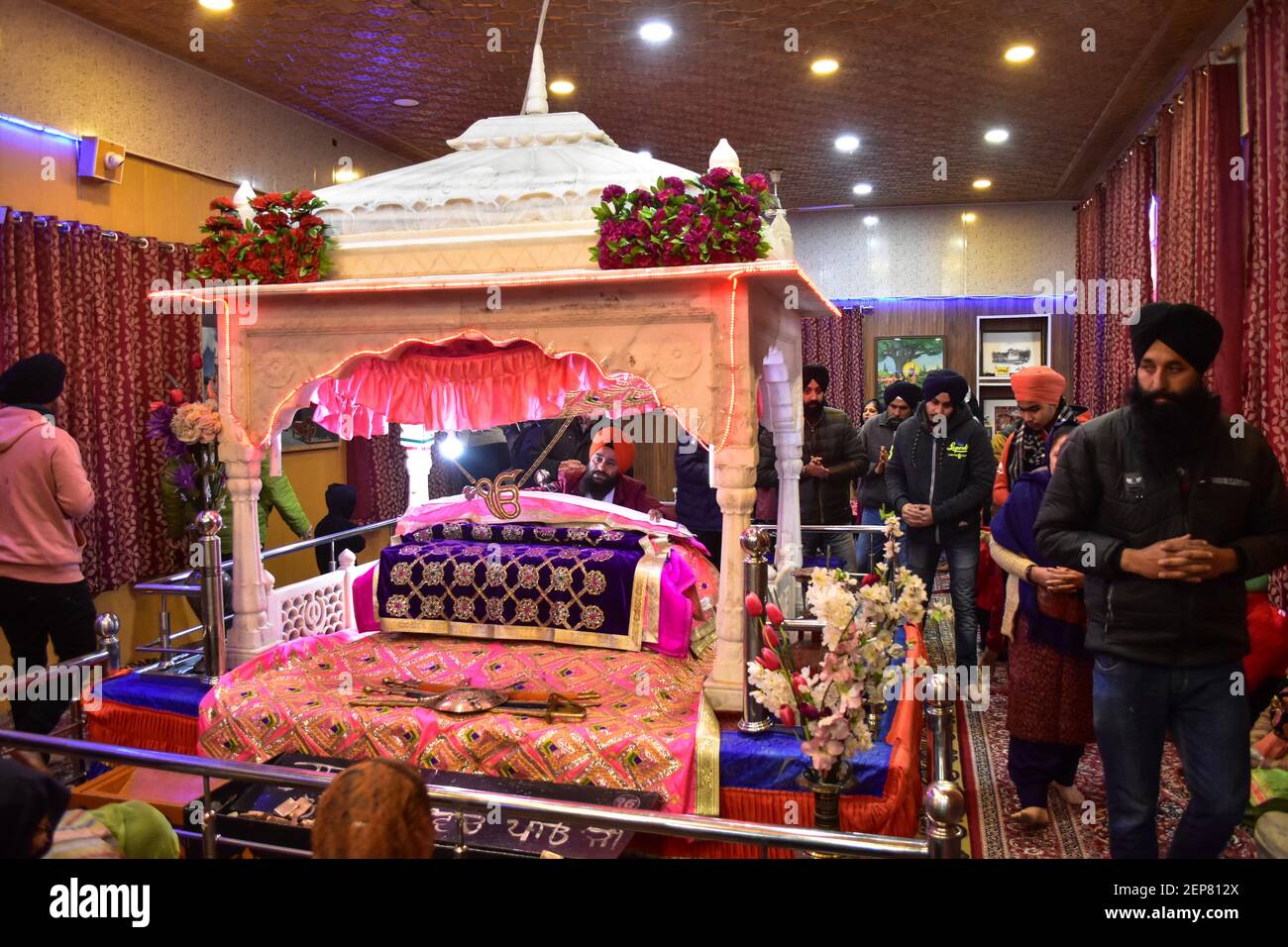 Sikh devotees perform rituals inside a Gurdwara or a Sikh temple during ...