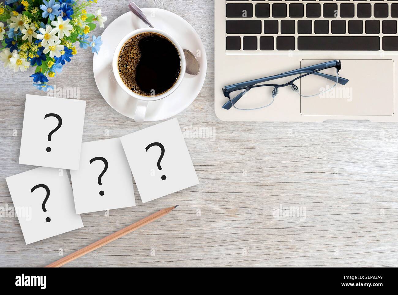 Top view with question mark on sticky notes on office desk with laptop ...