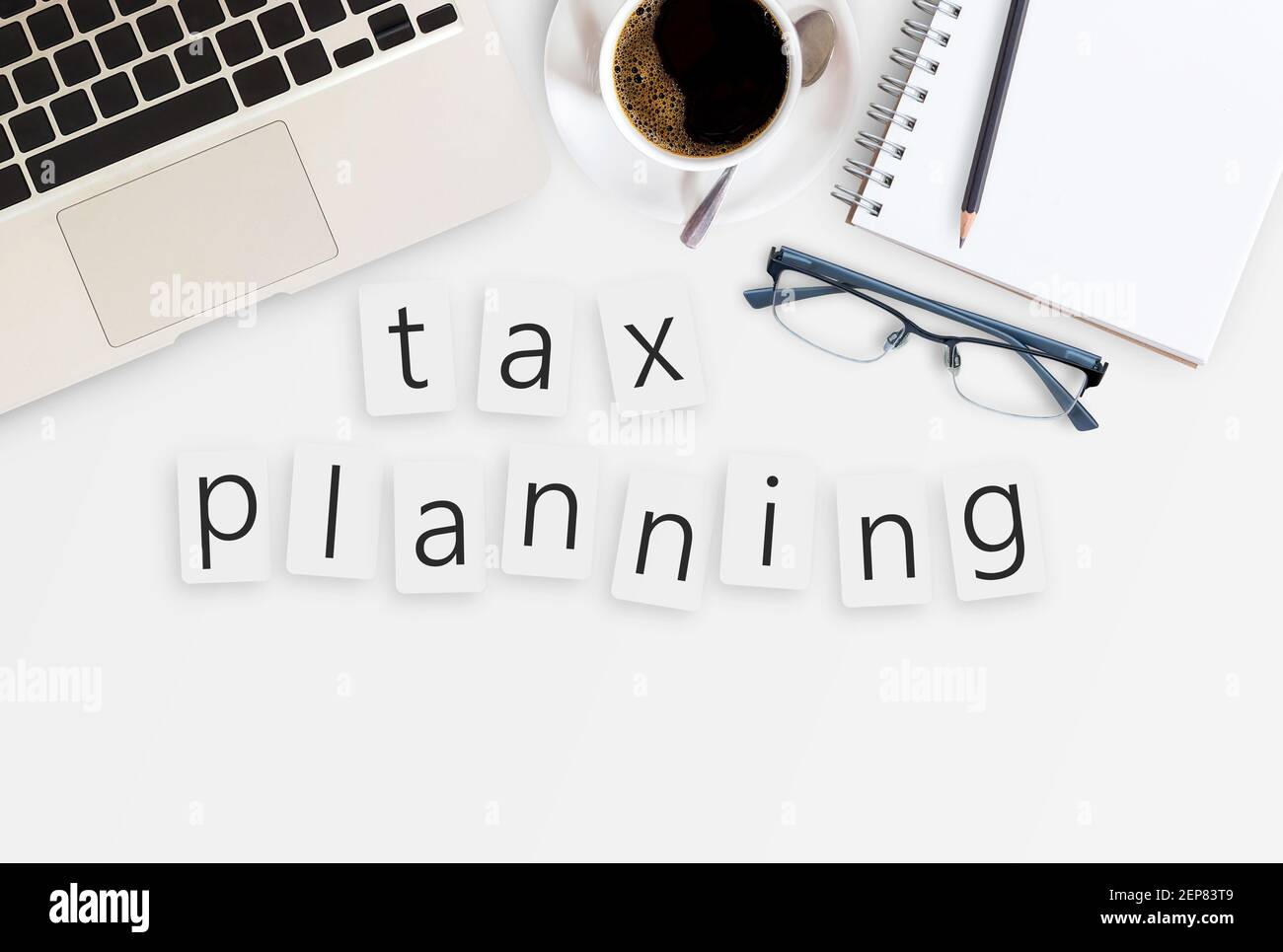 Top view with tax planning text on sticky notes on office desk with ...