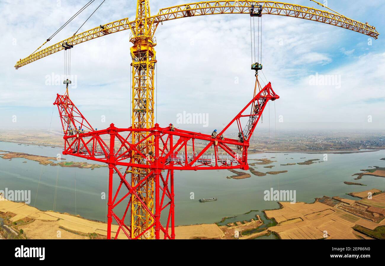 The workers are installing butt joint of electric tower cross arm at ...