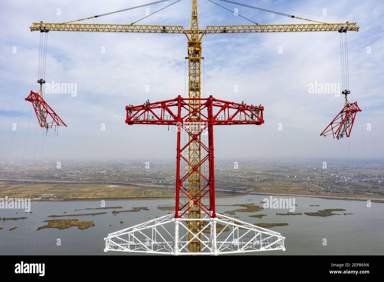 The workers are installing butt joint of electric tower cross arm at ...