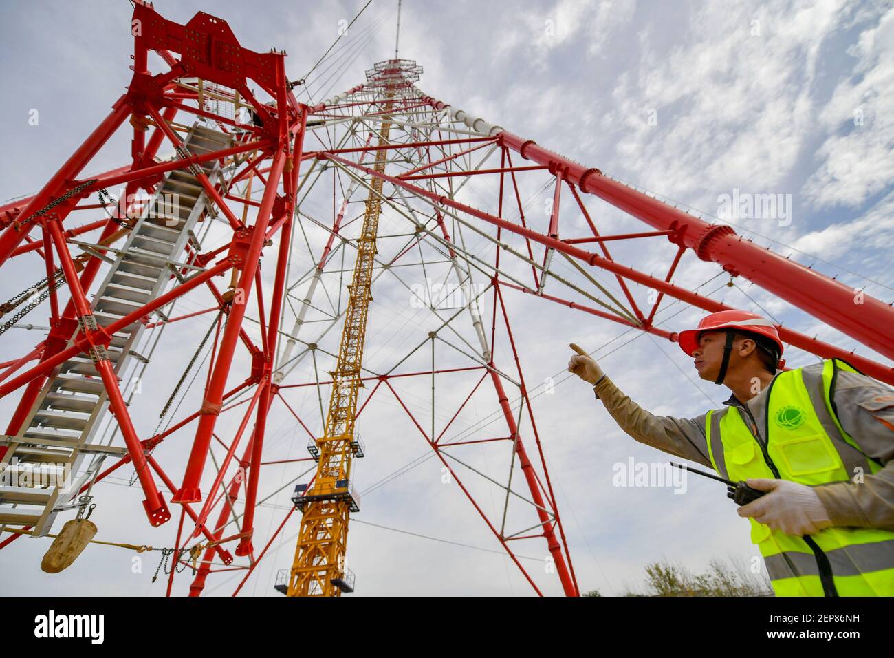 The workers are installing butt joint of electric tower cross arm at ...
