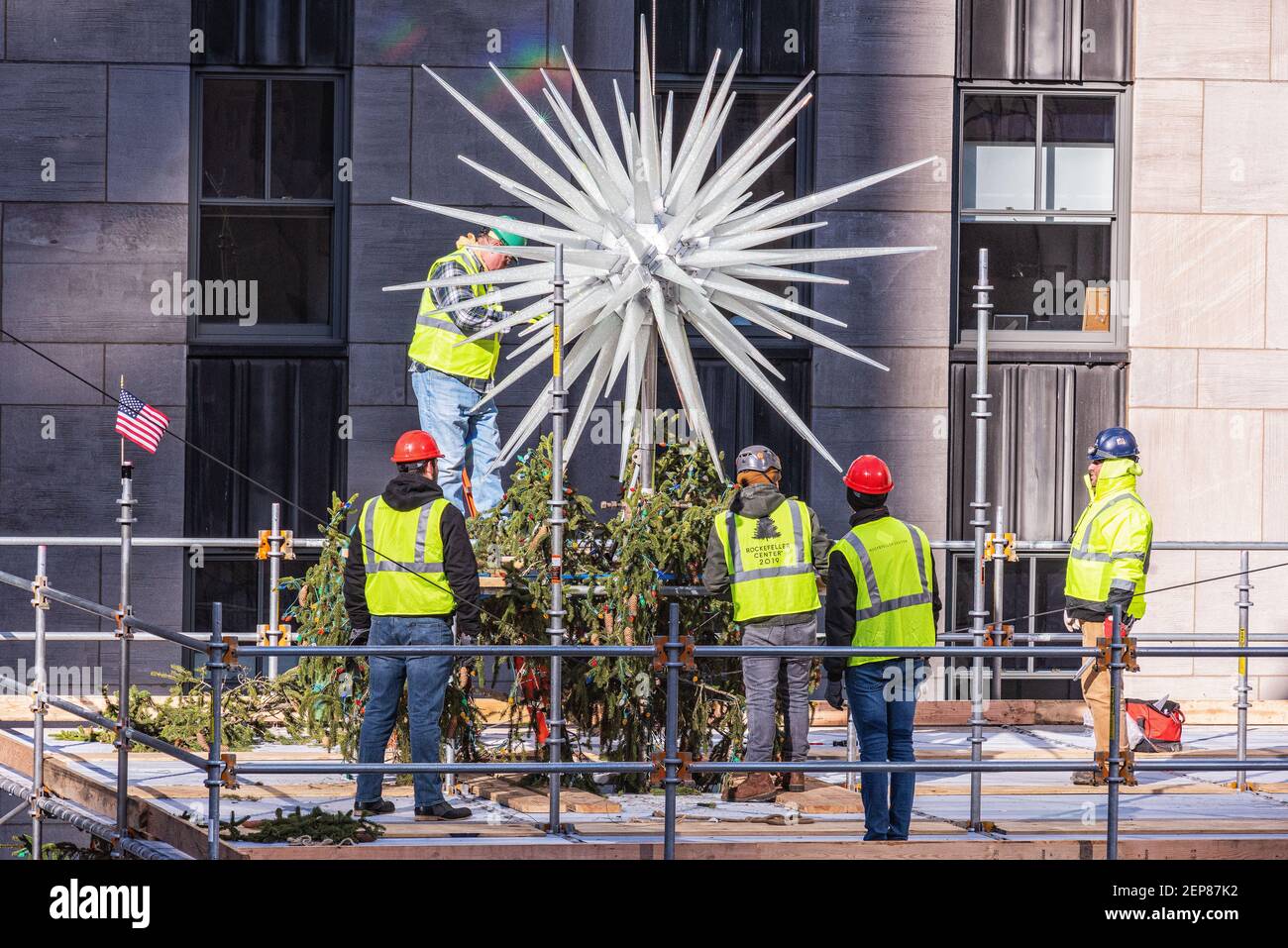 Workers attach the Swarovski Star to the Rockefeller Christmas Tree in ...