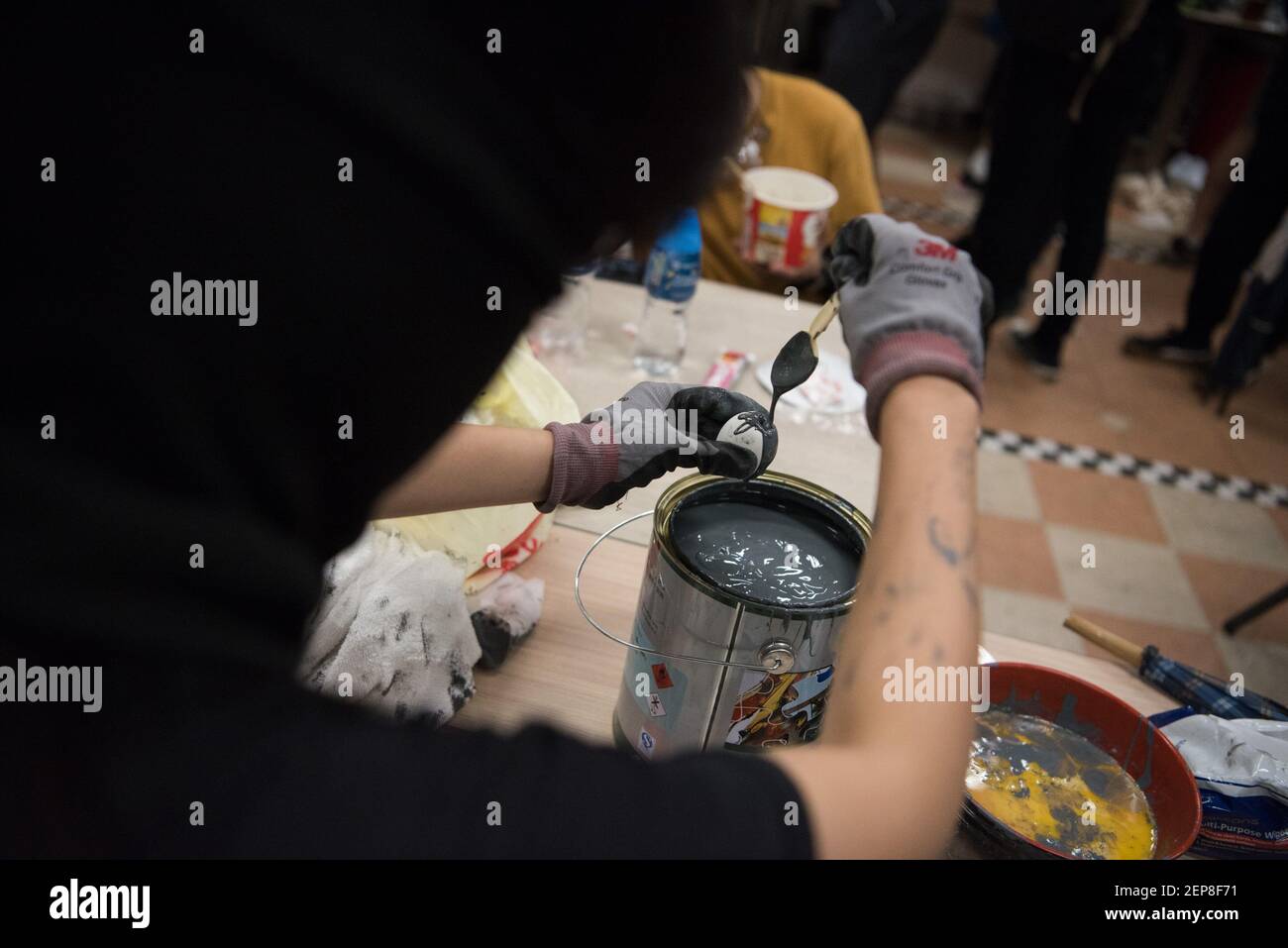 A protester fills egg shells with paint inside Hong Kong Polytechnic ...