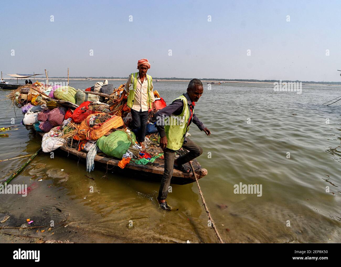 Workers from River Cleaning project collect garbage from the shores of ...