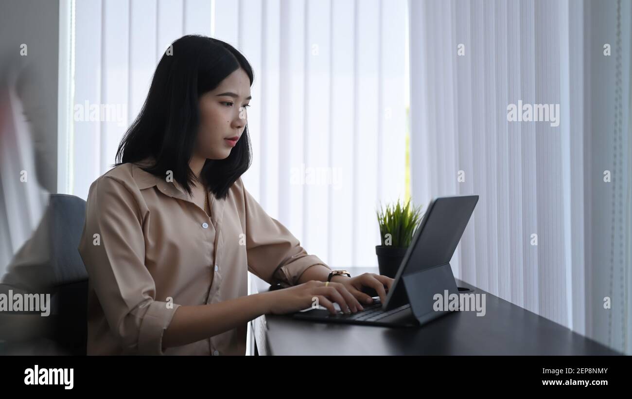 Attractive young woman office worker concentrate working on computer ...