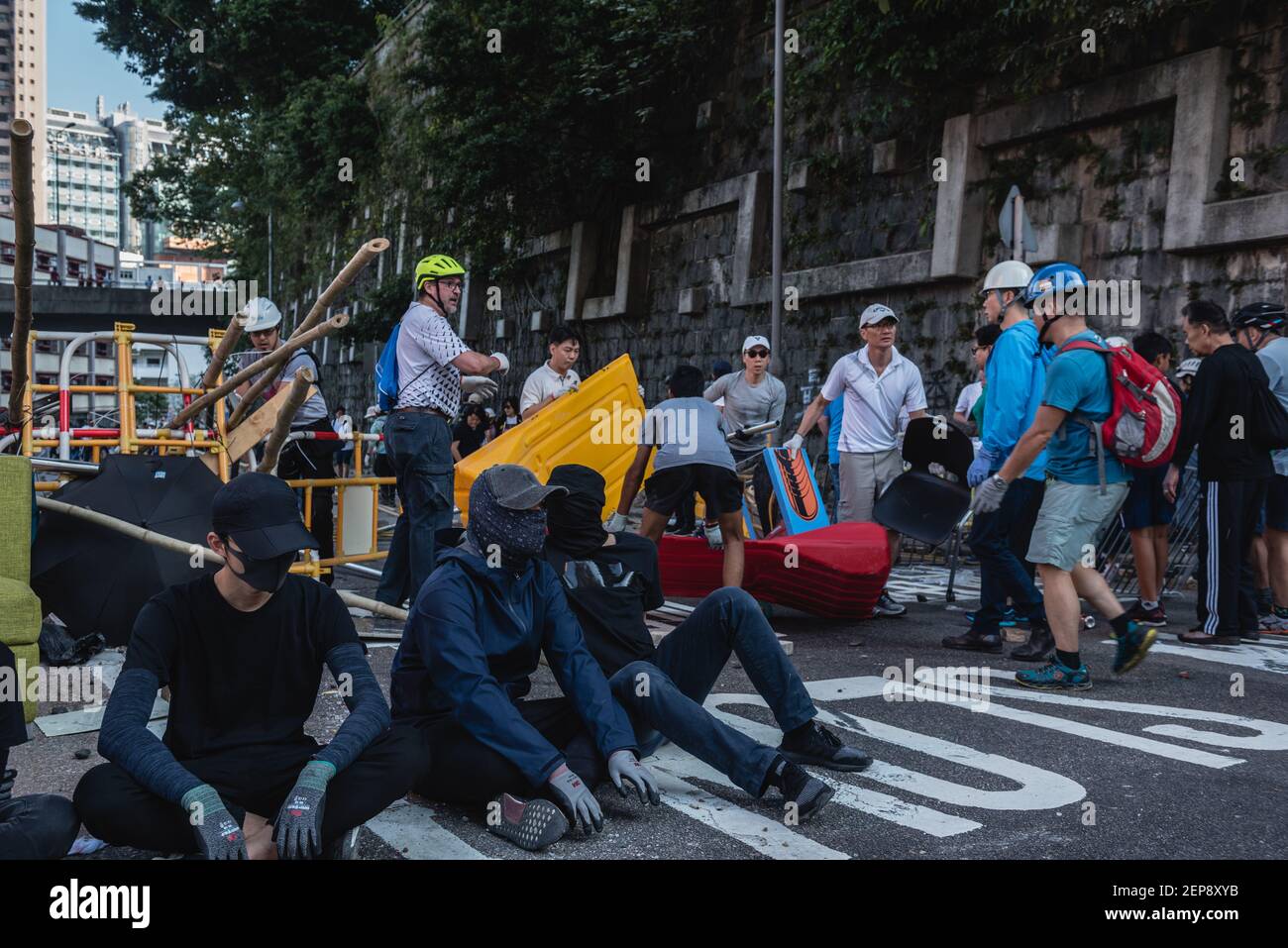Protesters occupy the street while local residents clear roadblocks and ...