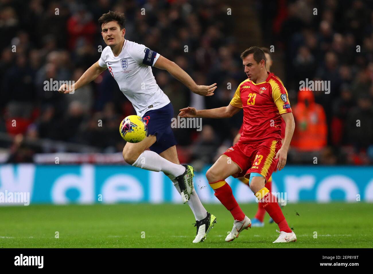 Harry Maguire of England and Branislav Jankovic of Montenegro in action ...