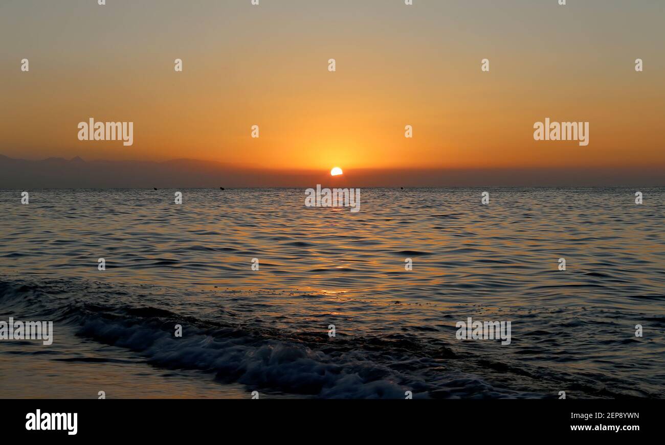 Waves of the sea, illuminated by sunlight at sunset. Costa del Sol ...