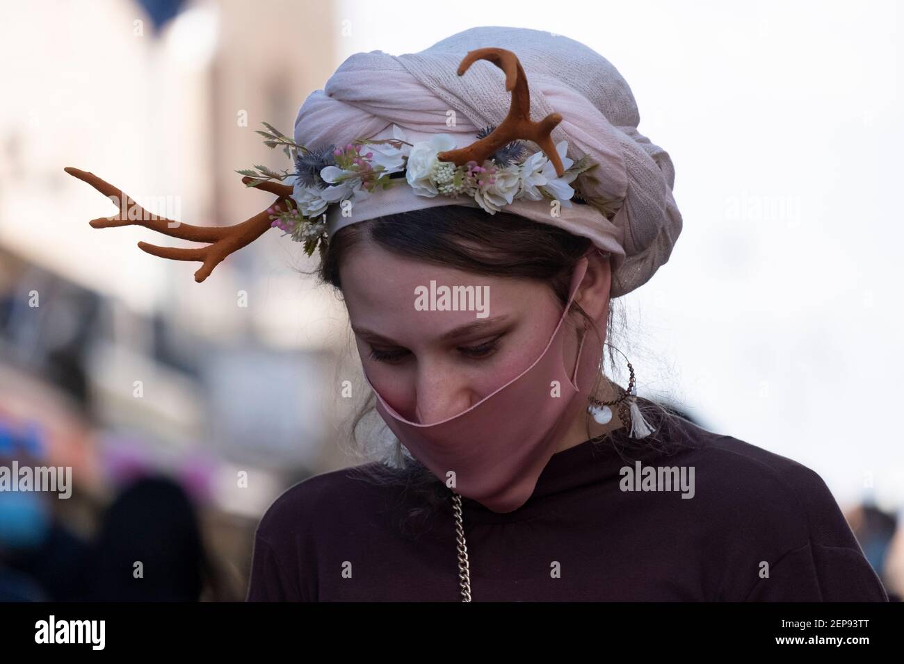 A religious Jewish woman with reindeer antlers wears face mask due to ...