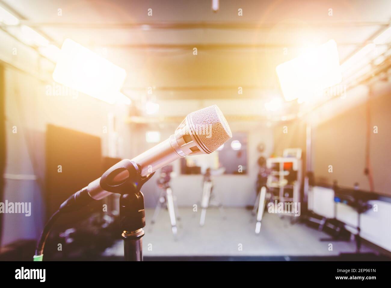 Professional microphone in recording tv studio, studio lights in blurry ...