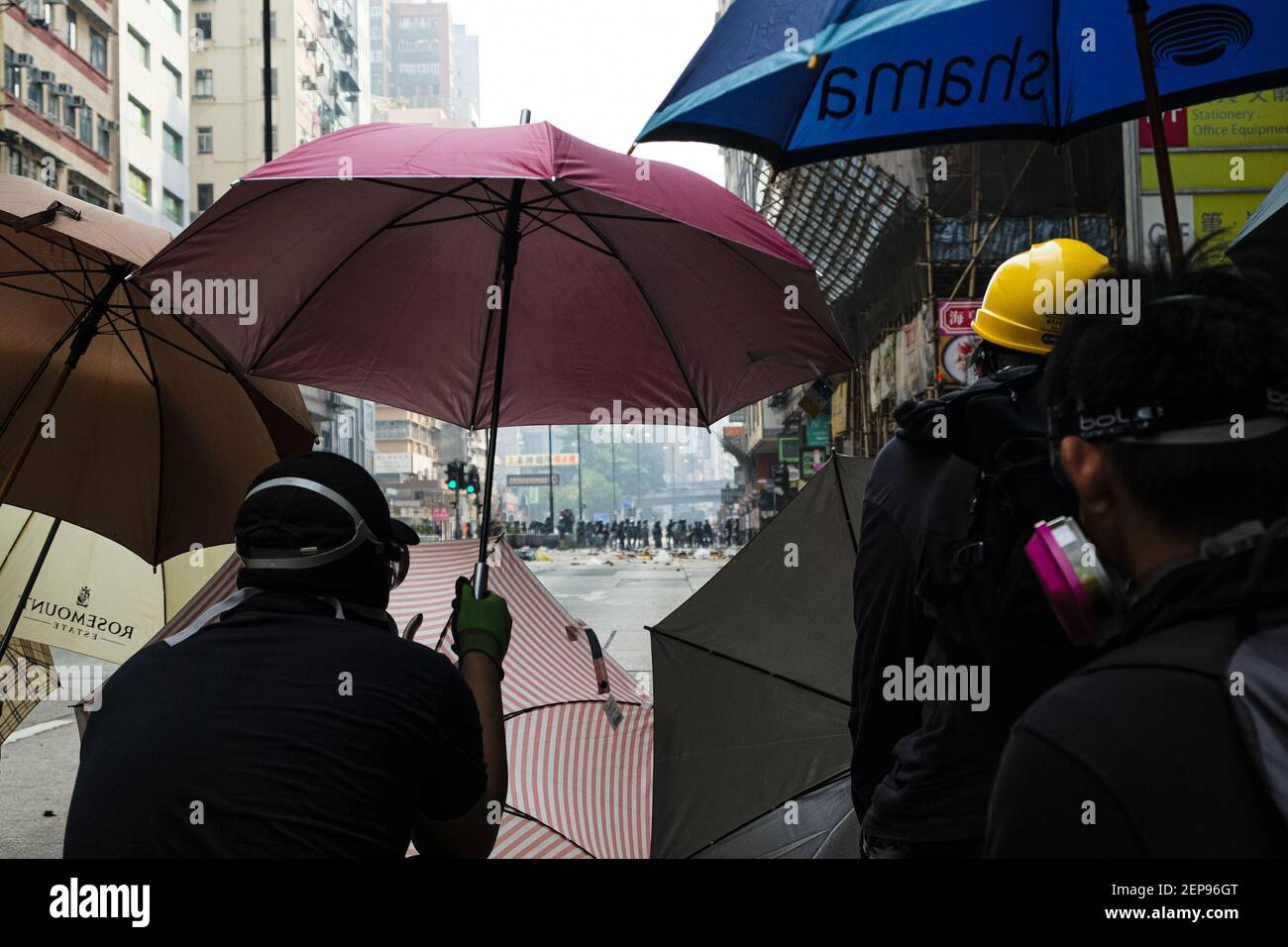Protesters Use Umbrellas As A Shield During The Clashes With The Riot