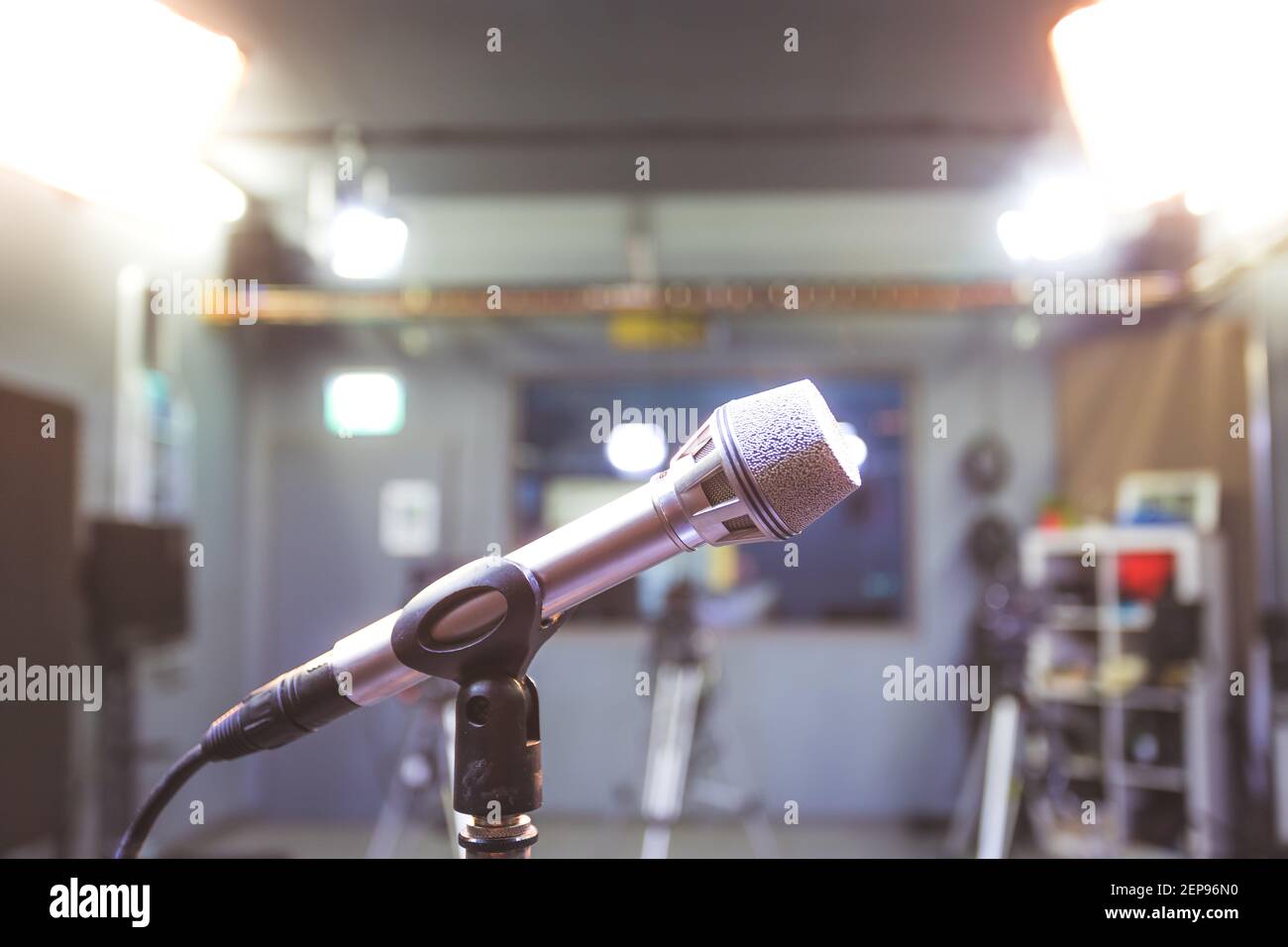 Professional microphone in recording tv studio, studio lights in blurry ...