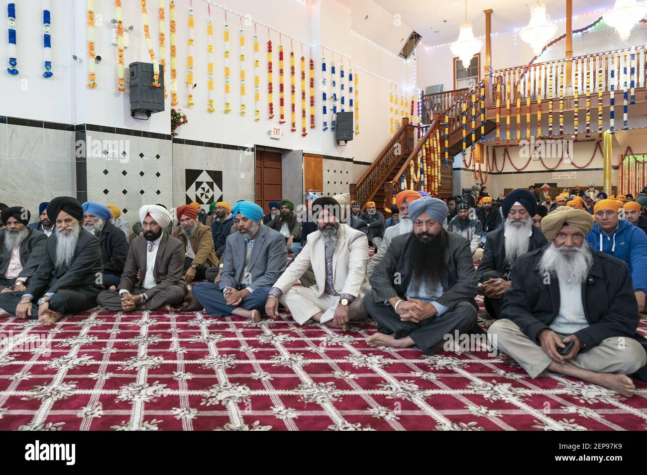 Men pray during 550th Birthday of Guru Nanak Dev Ji celebration at Baba ...